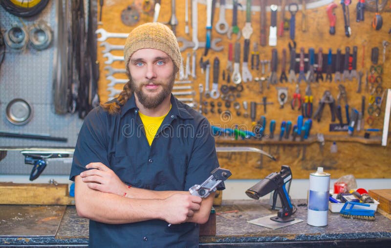 Handsome Guy in the Workshop with a Tool Stock Photo - Image of ...
