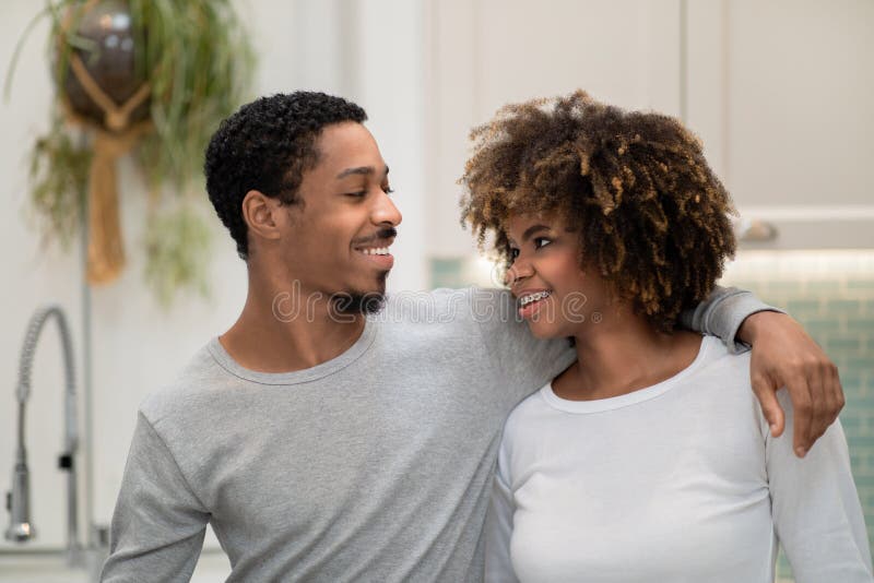Handsome Happy African American Husband Hugging Wife At Home Stock