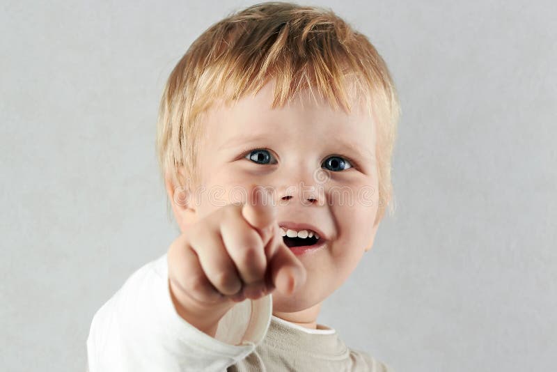 Handsome Happy Blond Boy Points Forward by Finger Stock Photo - Image ...
