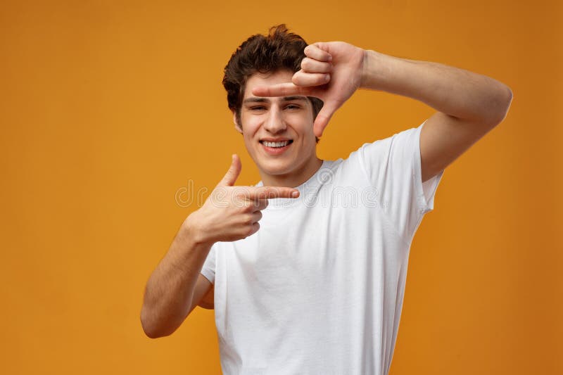 Handsome Happy Male Looking through a Frame Formed by His Hands Stock ...