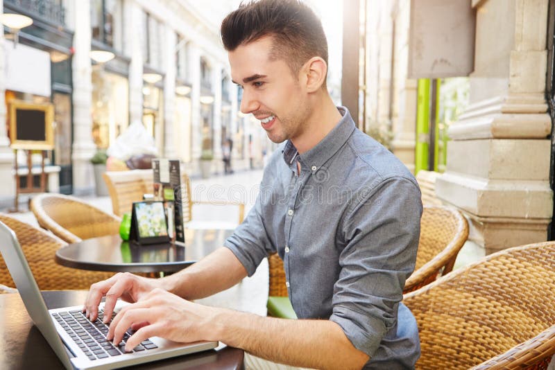 Handsome Happy Man Working at Cafe Typing on Laptop Stock Photo - Image ...
