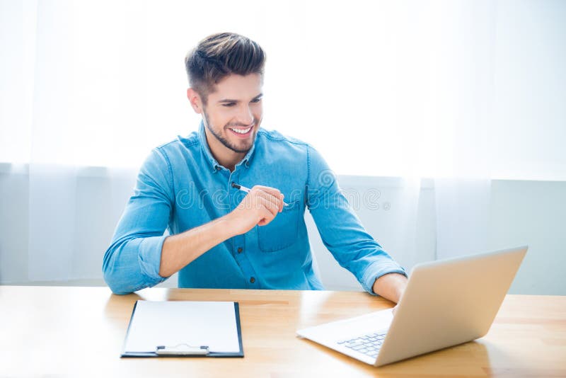 Handsome Happy Young Man Working on Laptop and Making Notes Stock Image ...