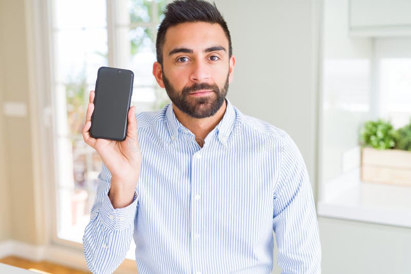 Handsome Hispanic Business Man Showing Smartphone Screen with a ... Handsome Hispanic Business Man Showing Smartphone Screen with a ...