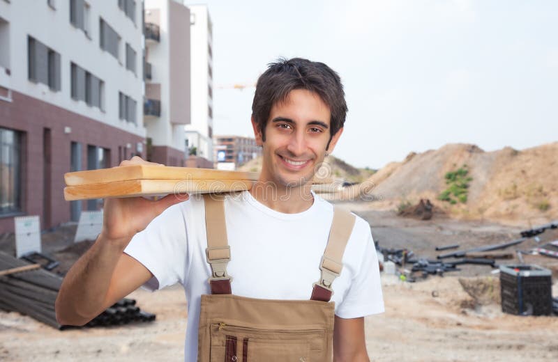 Hispanic Carpenter Lifting Roofing Panels Onto Roof Stock Image - Image ...