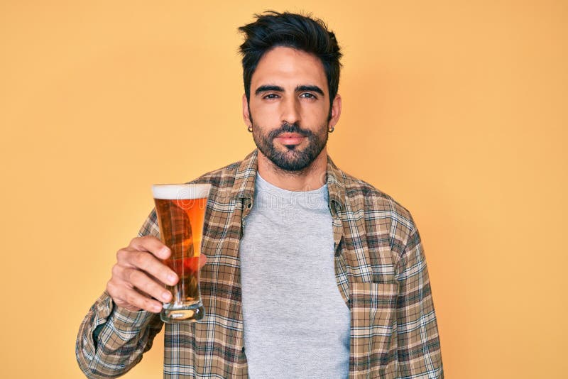 Handsome Hispanic Man with Beard Drinking a Pint of Beer Thinking ...
