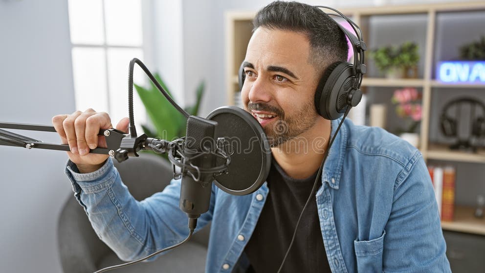 Handsome Hispanic Man with Beard Smiling while Recording in Modern ...