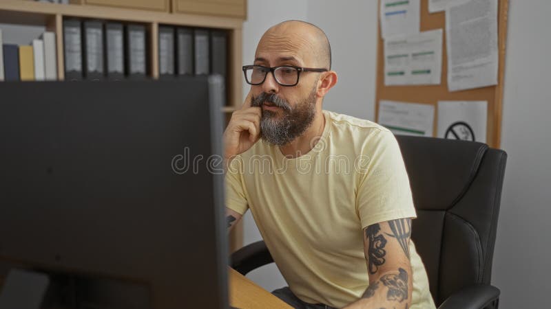 Handsome Hispanic Man with a Beard and Tattoos Working at a Desk in an ...