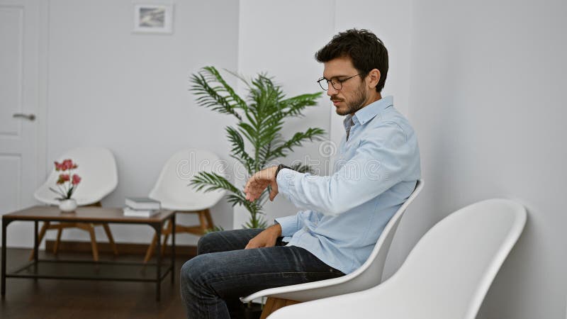 Handsome Hispanic Man Checking Time while Waiting in a Minimalist Room ...