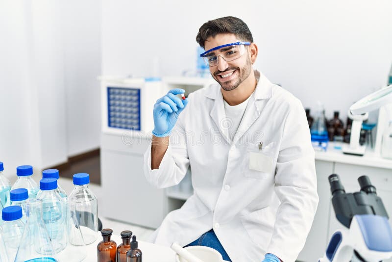 Handsome Hispanic Man Holding Pharmaceutical Pill at Laboratory Stock ...