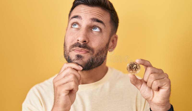 Handsome Hispanic Man Holding Tron Cryptocurrency Coin Serious Face ...