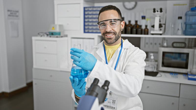 Handsome Hispanic Man in Lab Coat Holding Beaker in Laboratory ...