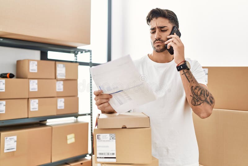 Handsome Hispanic Man Speaking on the Phone Asking for Address at E ...