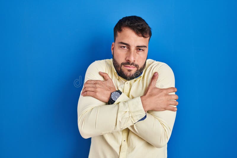 Handsome Hispanic Man Standing Over Blue Background Shaking and ...