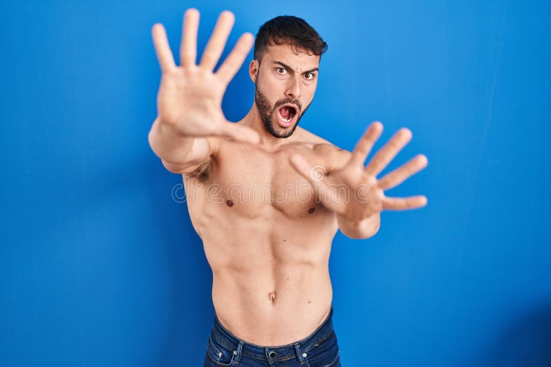 Handsome Hispanic Man Standing Shirtless Afraid and Terrified with Fear ...