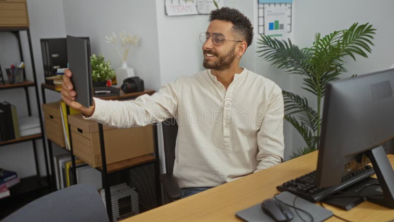 Handsome Hispanic Man Taking a Selfie in a Modern Office Workspace ...