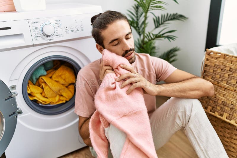 Handsome Hispanic Man Touching Soft and Fresh Laundry at Laundry Room ...