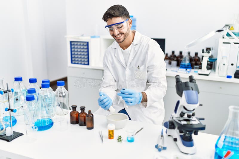 Handsome Hispanic Man Using Scientific Mortar at Laboratory Stock Image ...