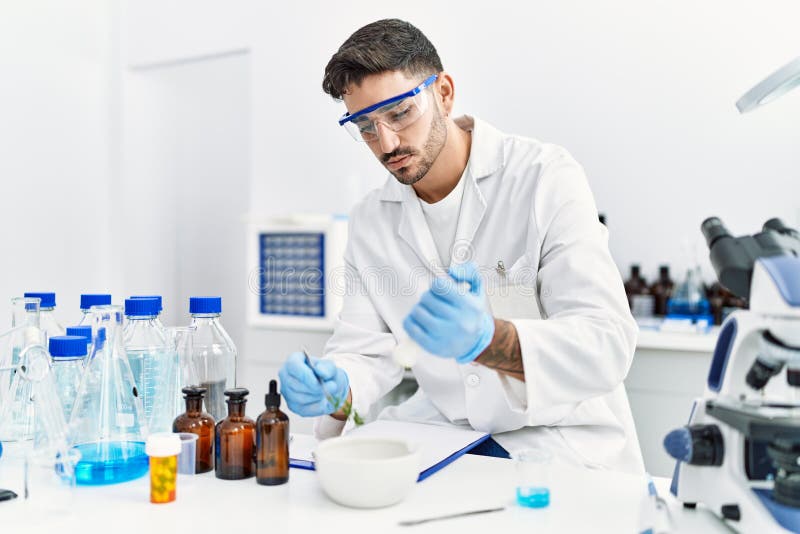 Handsome Hispanic Man Using Scientific Mortar at Laboratory Stock Photo ...