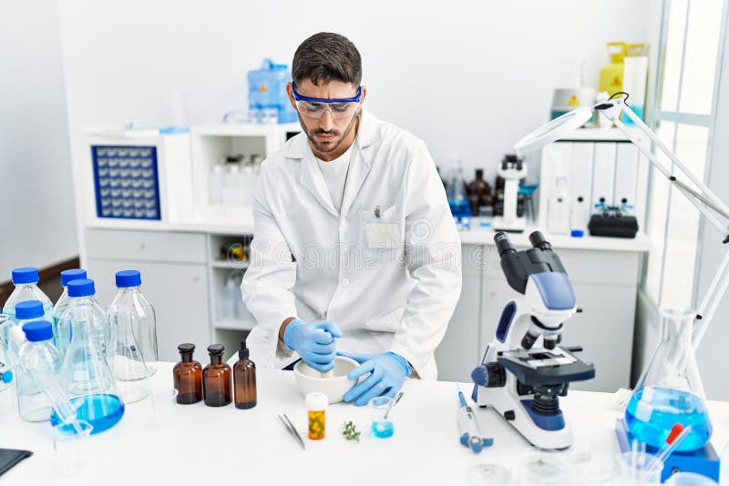 Handsome Hispanic Man Using Scientific Mortar at Laboratory Stock Photo ...