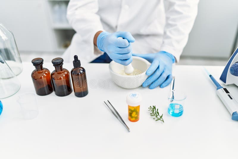 Handsome Hispanic Man Using Scientific Mortar at Laboratory Stock Photo ...
