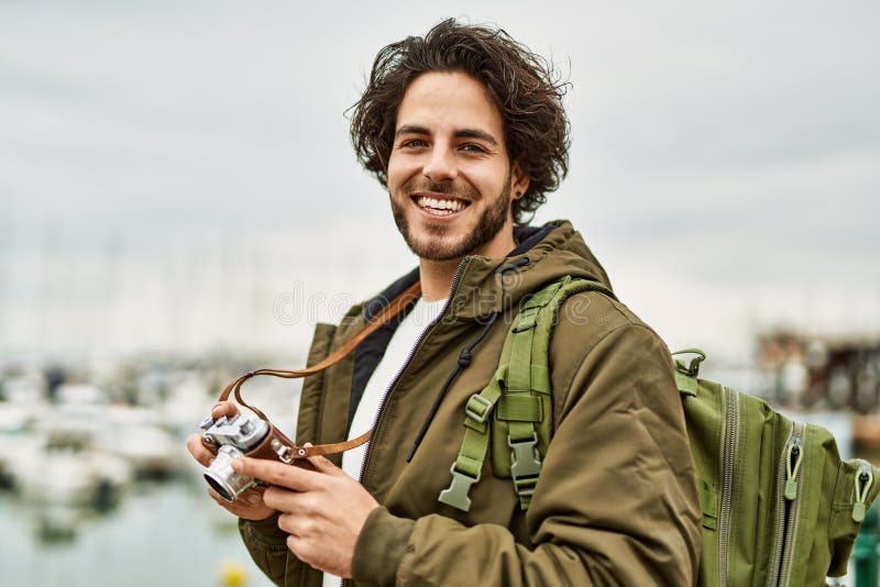 Handsome Hispanic Man Using Vintage Camera by Marina Port Stock Photo ...
