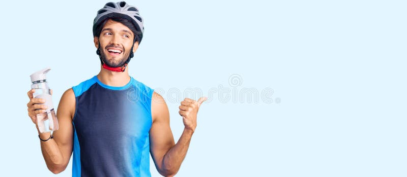 Handsome Hispanic Man Wearing Bike Helmet And Holding Water Bottle