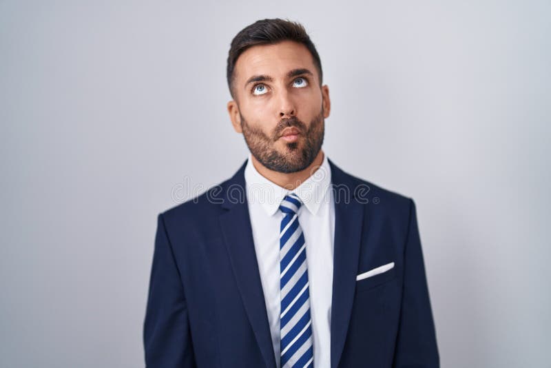 Handsome Hispanic Man Wearing Suit and Tie Making Fish Face with Lips ...