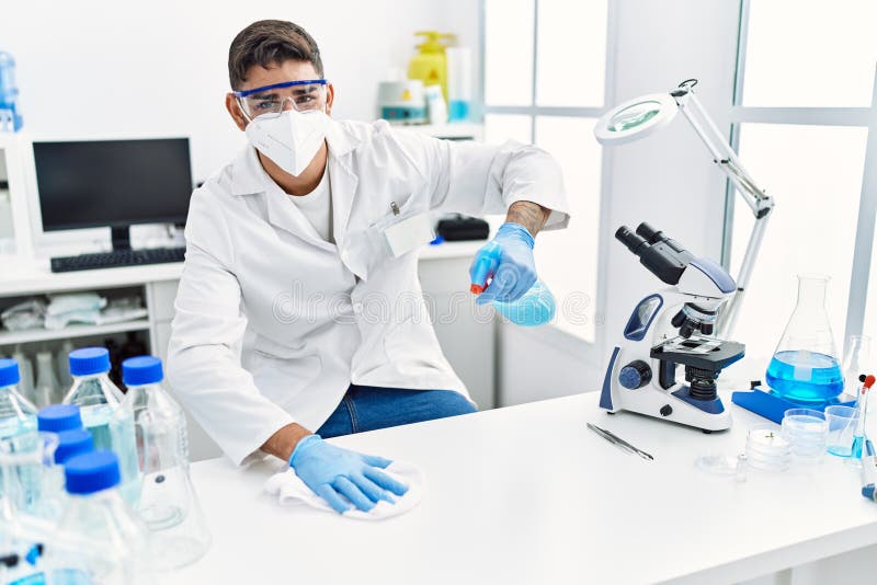 Handsome Hispanic Man Working As Scientific Cleaning the Table at ...