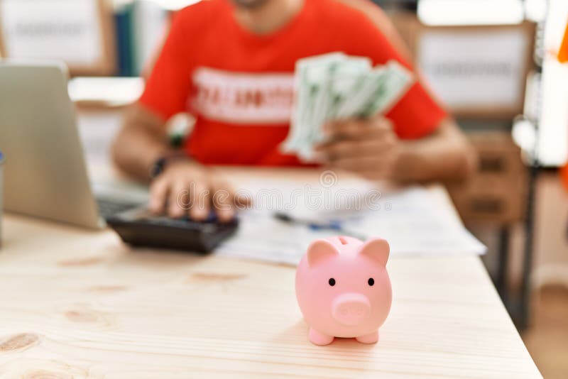 Handsome Hispanic Man Working As Volunteer Calculating Donations at ...