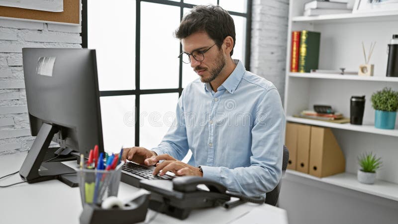 Handsome Hispanic Man Working on Computer in Modern Office Setting ...