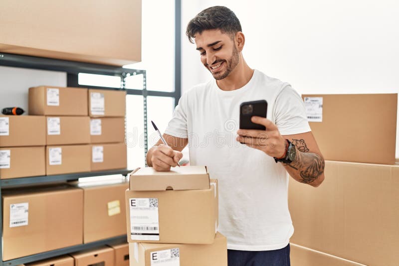 Handsome Hispanic Man Writing Address on Cardboard Boxes at E-commerce ...
