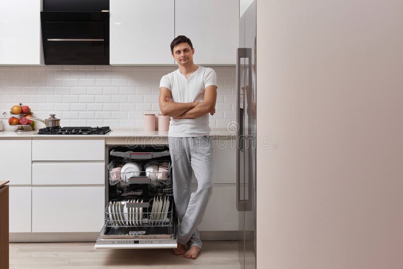 Handsome Husband Man Using Dishwasher in White Modern Kitchen Stock ...