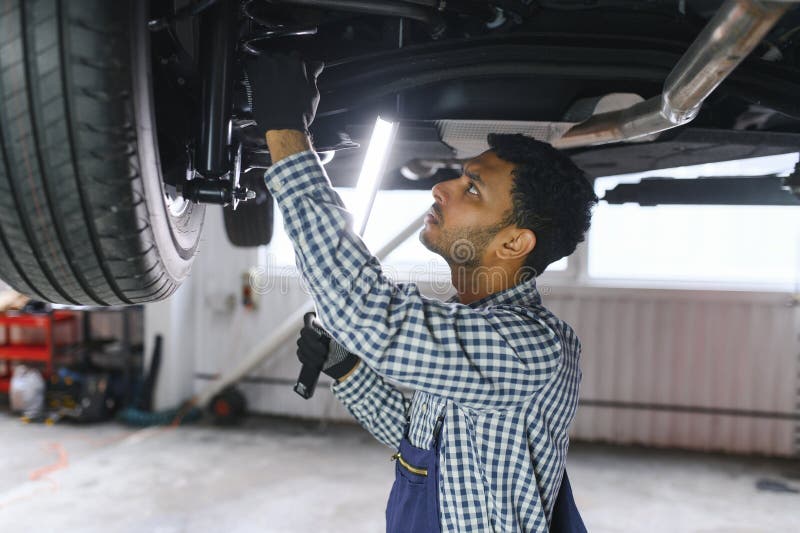 Indian Man Auto Mechanic Working Indoors in Car Shop Stock Image ...