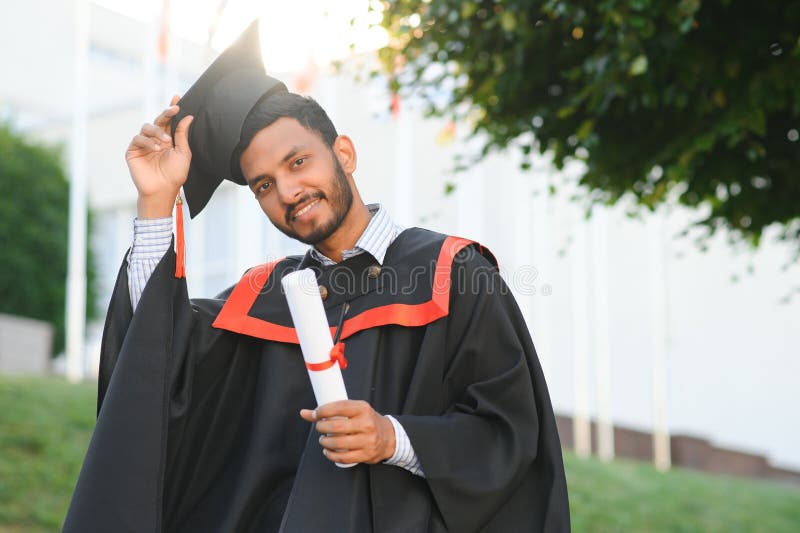 Handsome Indian Graduate in Graduation Glow with Diploma. Stock Photo ...