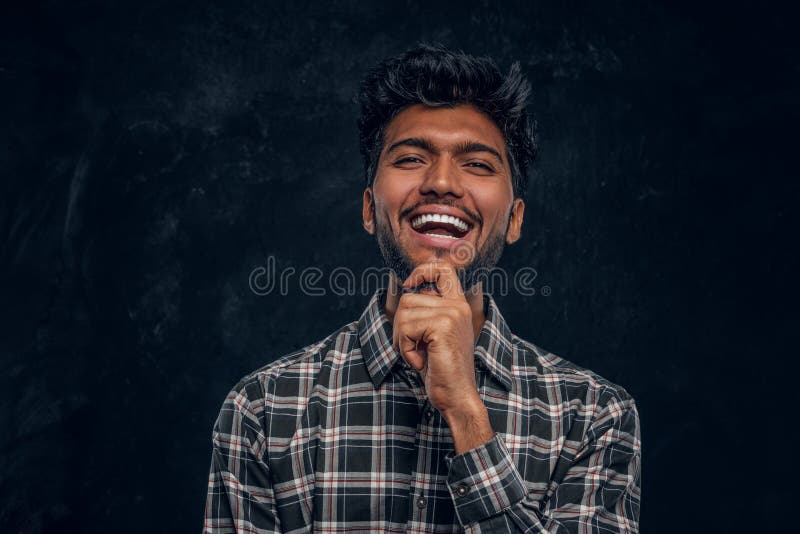 Handsome Indian Guy In Plaid Shirt Looks At The Camera With A Piercing