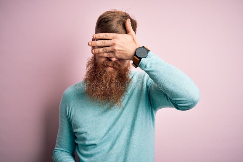 Handsome Irish Redhead Man With Beard Wearing Glasses Over Pink
