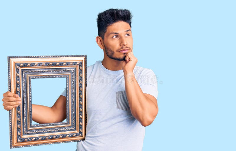 Handsome Latin American Young Man Holding Empty Frame Serious Face ...
