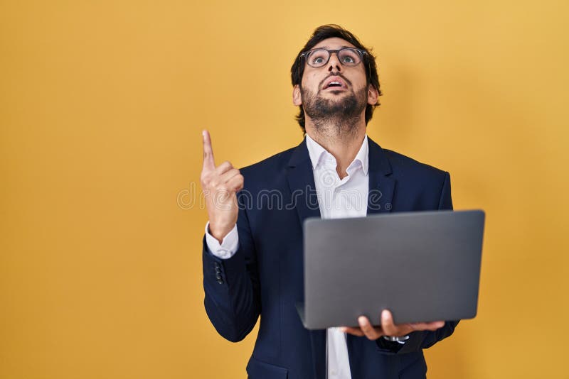 Handsome Latin Man Working Using Computer Laptop Amazed and Surprised ...