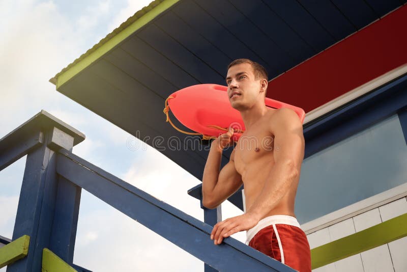 Handsome Lifeguard with Life Buoy on Watch Tower, Low Angle View Stock ...