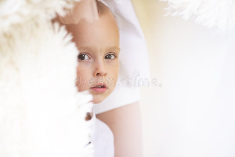 A Handsome Little Boy Peeps Out Stock Photo - Image of cheerful, face ...