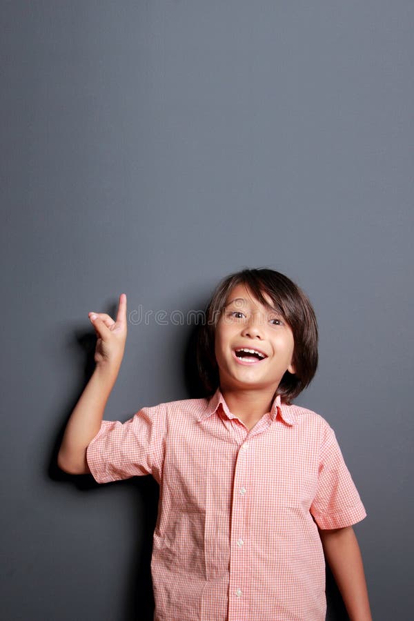 Handsome Little Boy Pointing Upwards Stock Photo - Image of brown ...