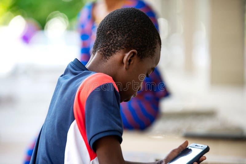 Handsome Little Boy Using a Mobile Phone Outside Stock Photo - Image of ...