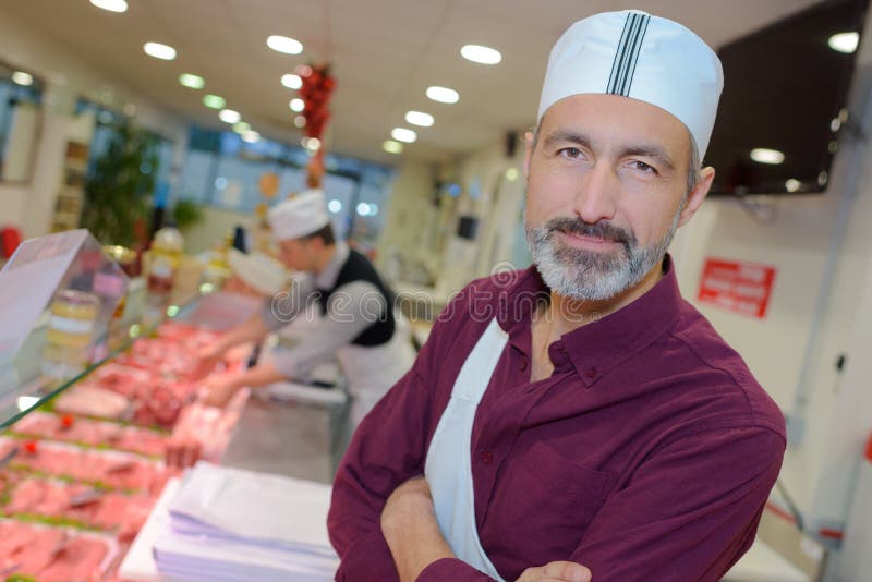 Handsome Male Butcher Working with Meat in Store Stock Photo - Image of ...