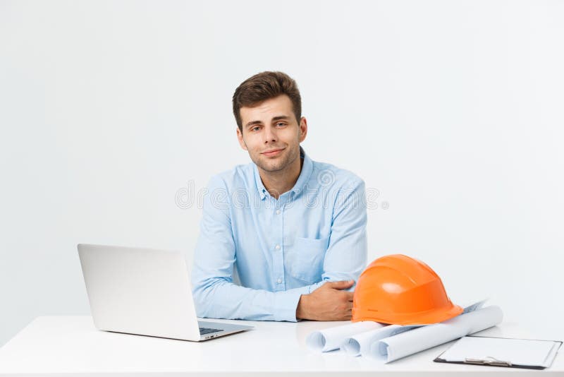 Handsome Male Construction Engineer Working in the Office with Laptop ...