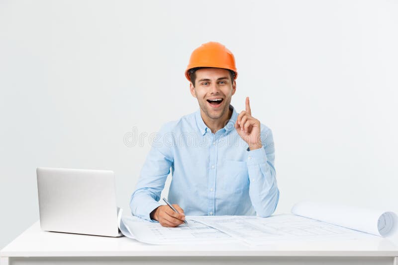 Handsome Male Construction Engineer Working in the Office with Laptop ...