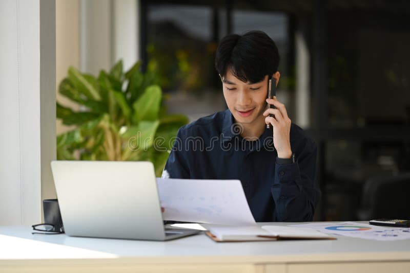 Handsome Male Financial Advisor Looking at Document and Talking on ...