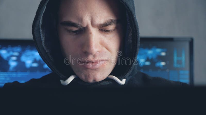 Male Hacker Programmer Working at Computer while Blue Code Characters ... Male Hacker Programmer Working at Computer while Blue Code Characters ...
