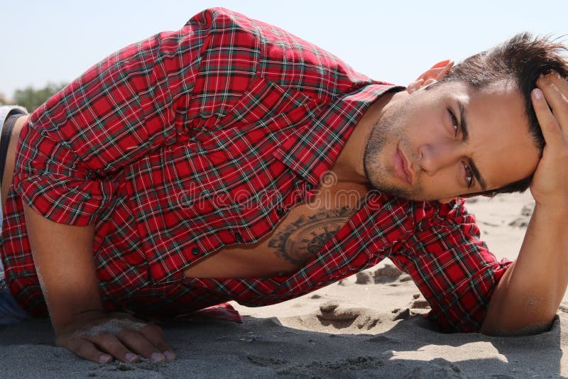 Handsome Male Lying on the Sand Stock Image - Image of beautiful, brown ...