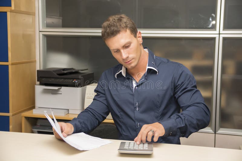 Handsome Male Office Worker Using Calculator Stock Image - Image of ...