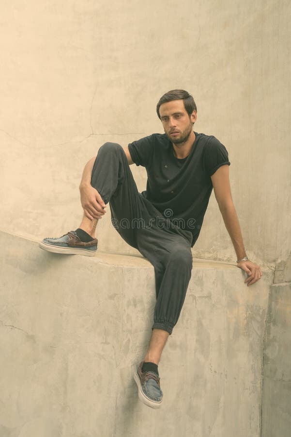 Handsome Man Against Concrete Wall in the Streets Outdoors Stock Photo ...